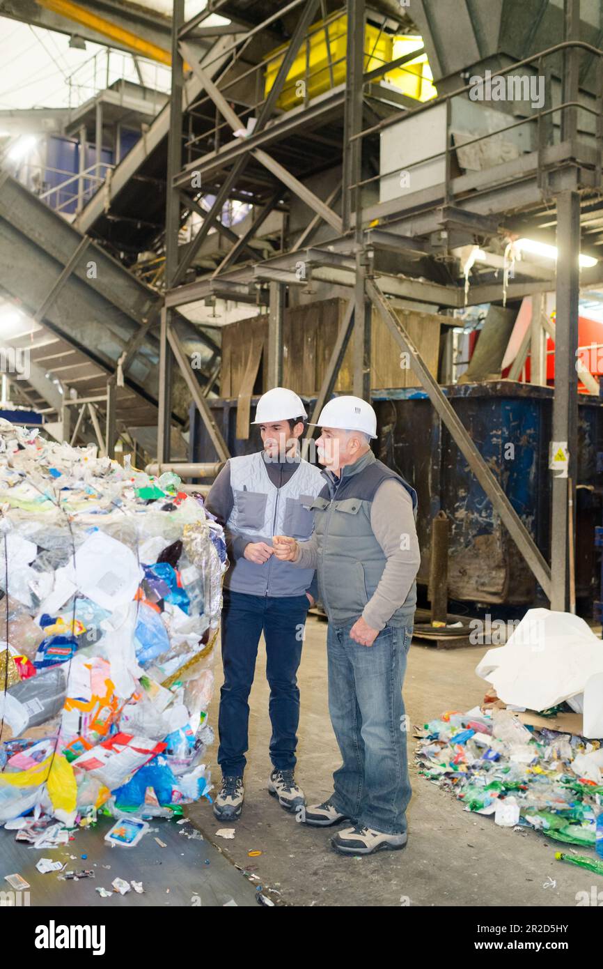 sanitation workers in recycling plant Stock Photo - Alamy