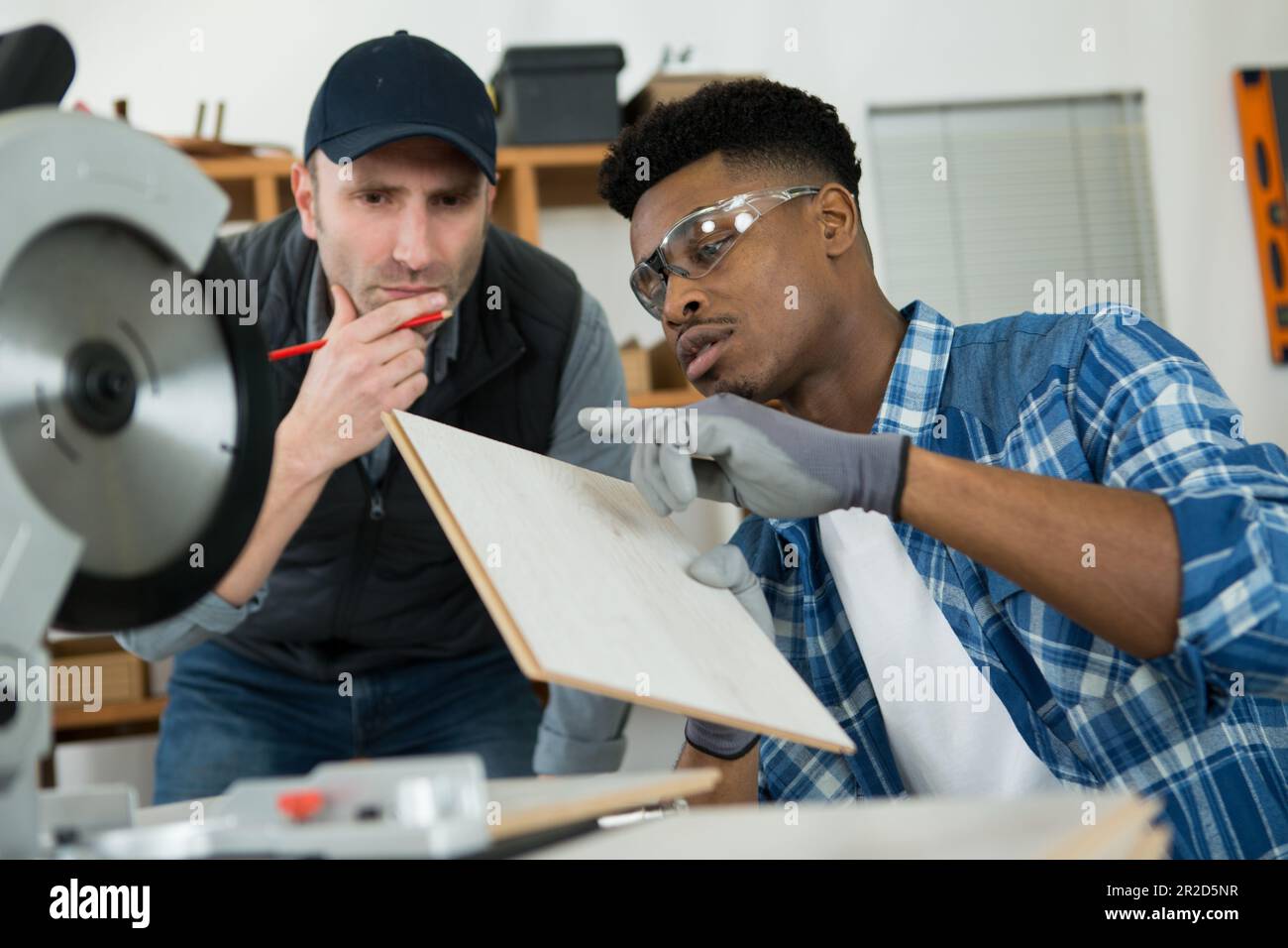 student and teacher in carpentry class using circular saw Stock Photo ...