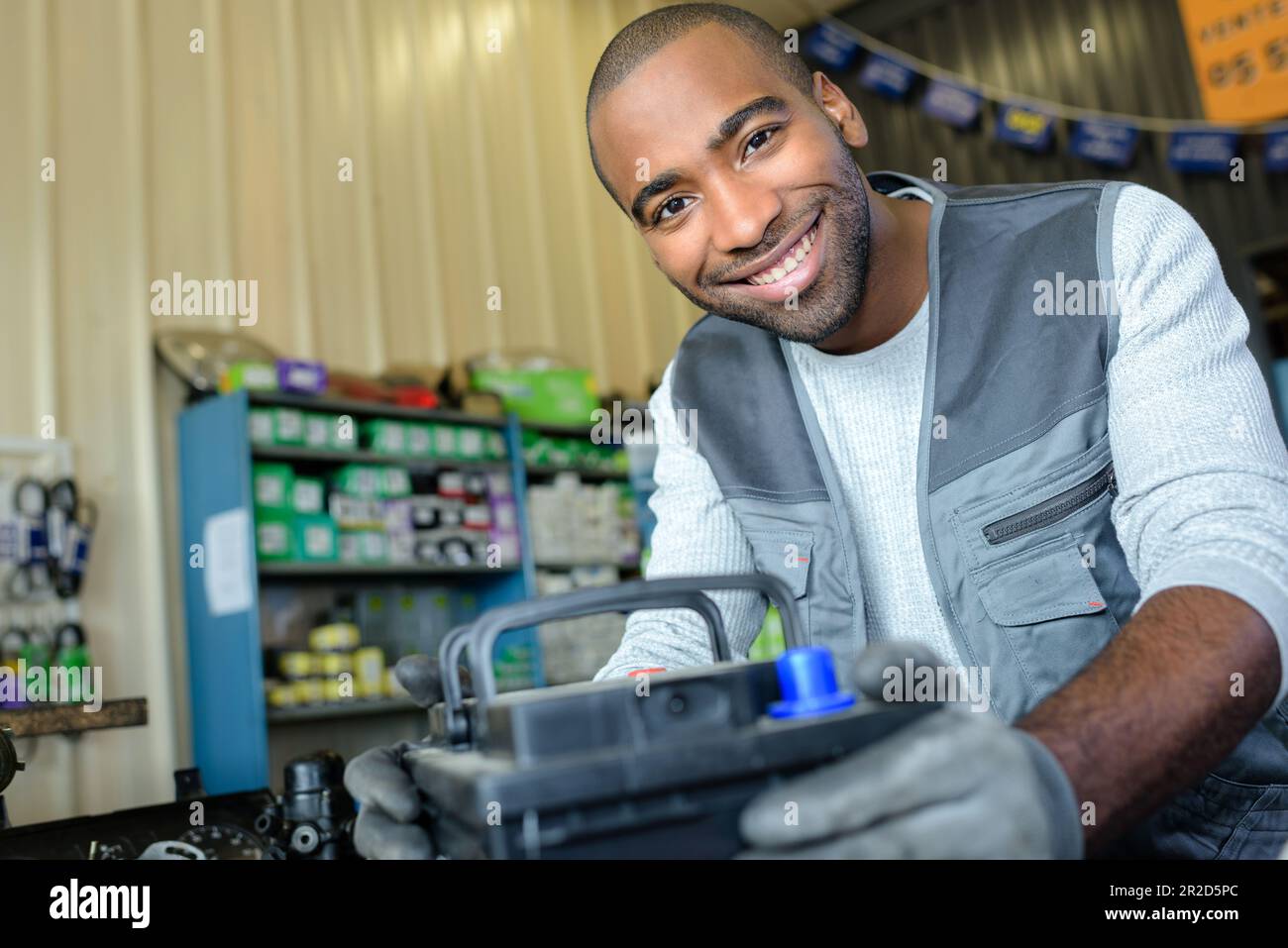 a mechanic changing car battery Stock Photo - Alamy
