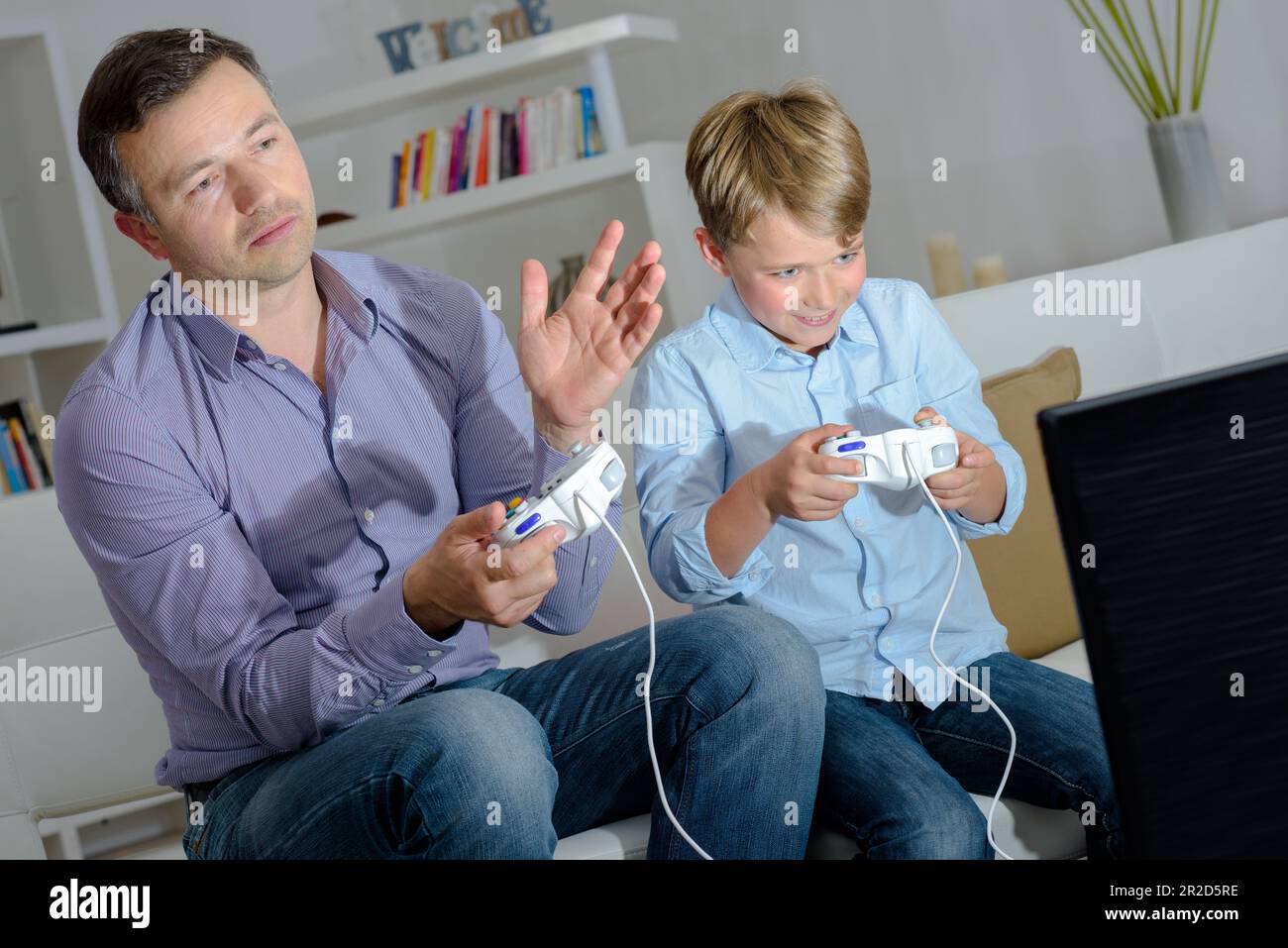 dad with his son playing video games Stock Photo - Alamy