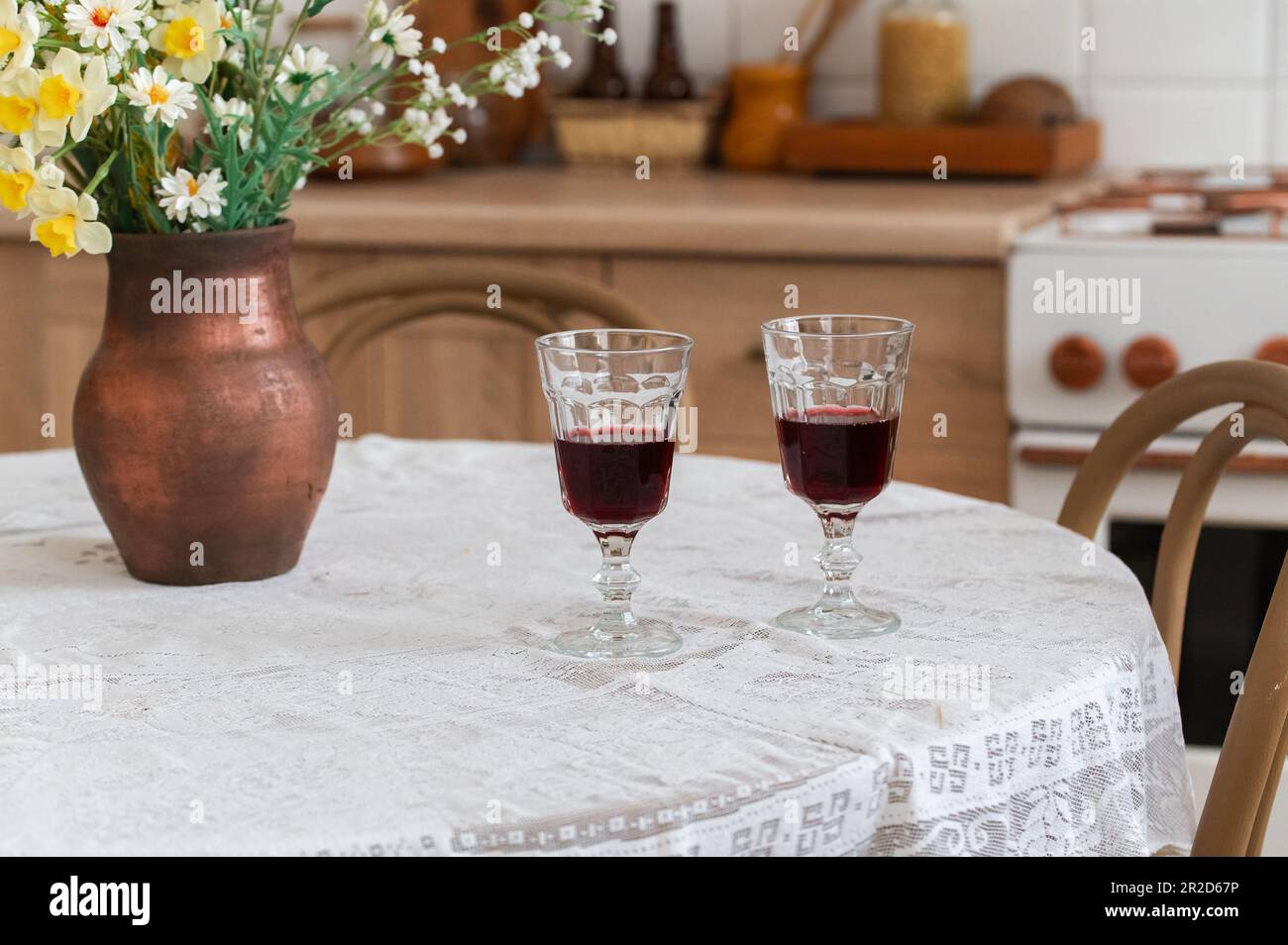 a glass of red wine on the kitchen table. rustic style Stock Photo - Alamy