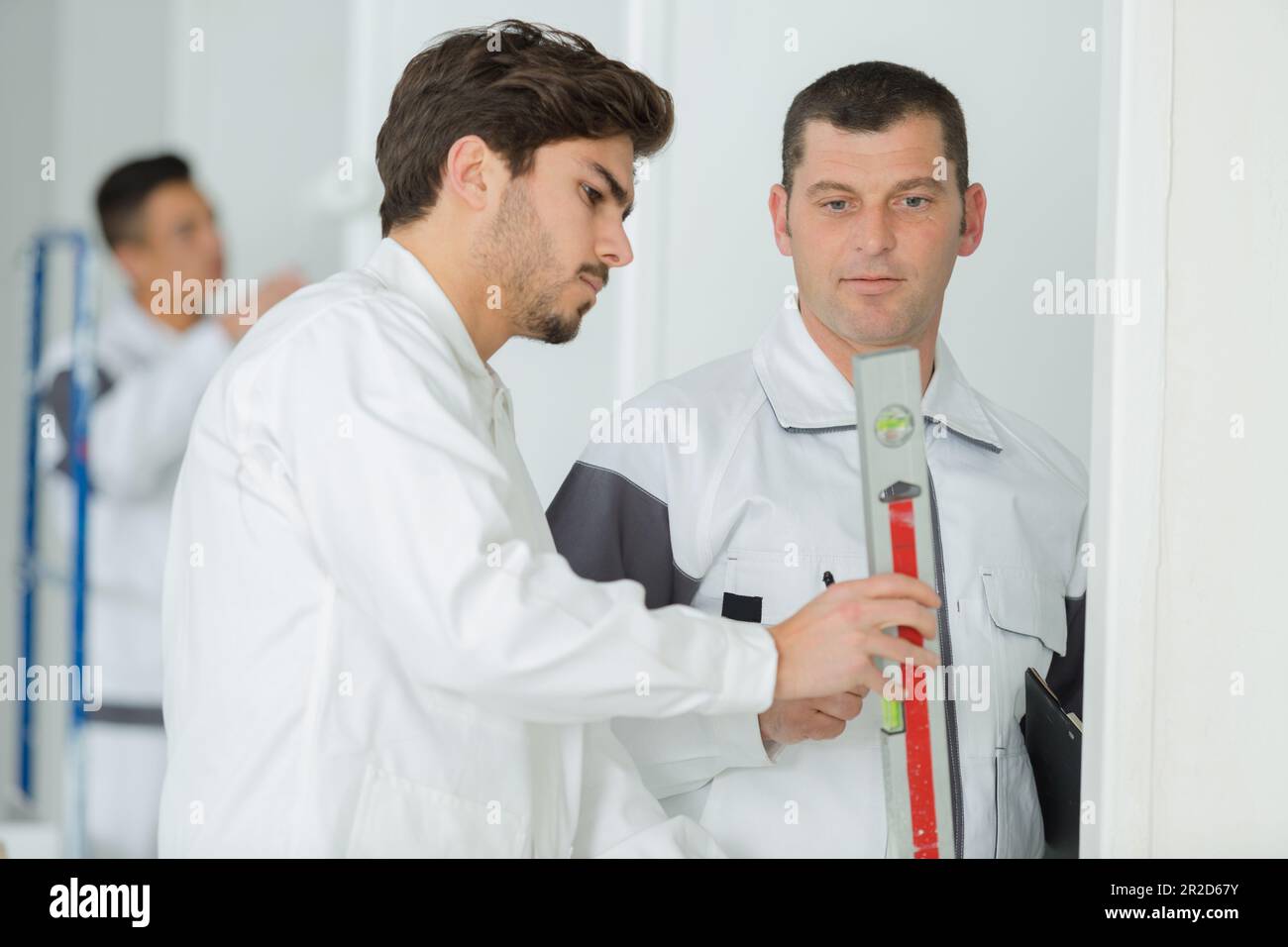 young worker using a level Stock Photo - Alamy