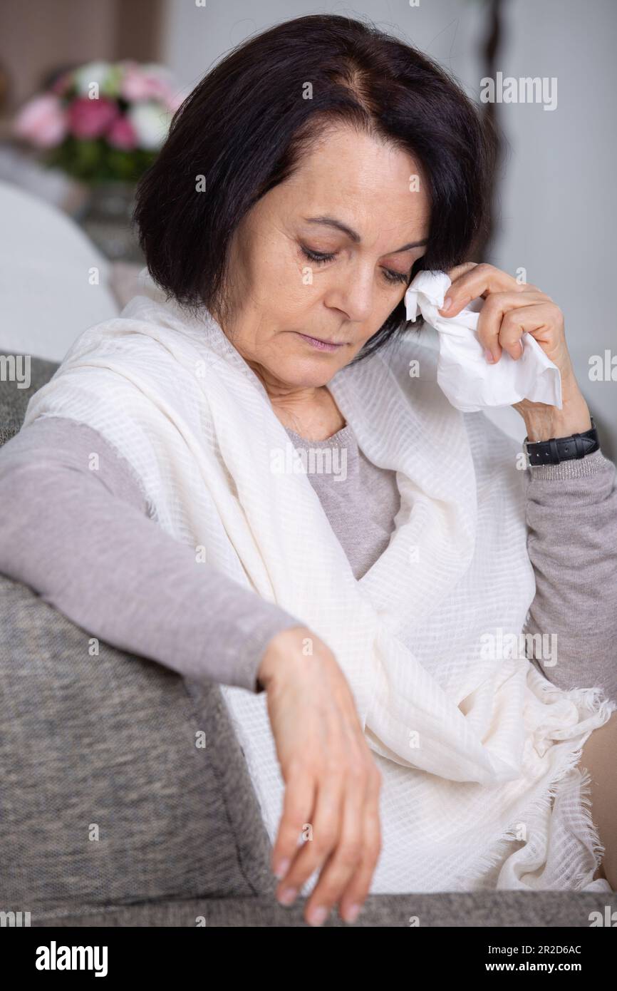 upset woman is crying on the sofa Stock Photo - Alamy