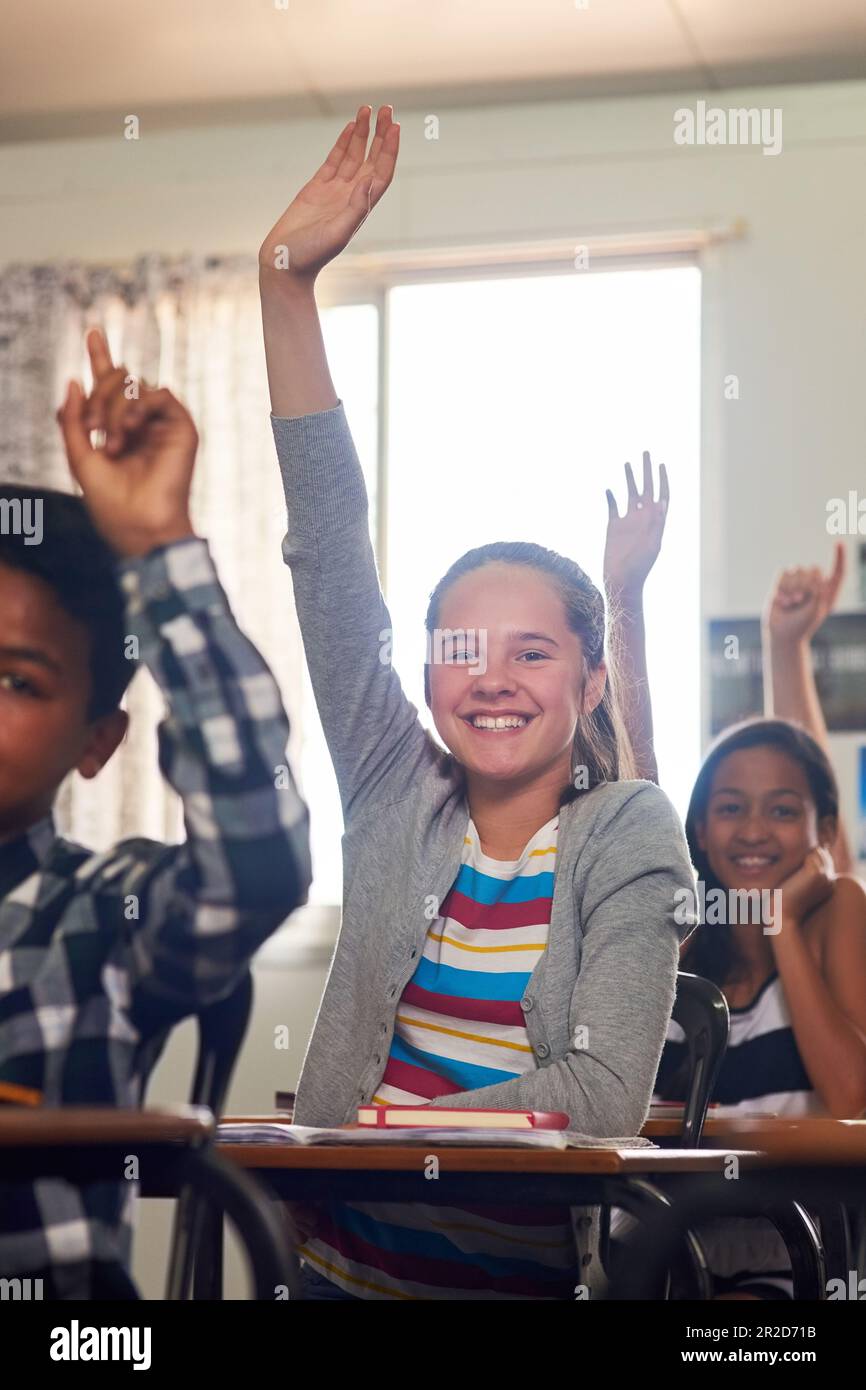 Hands up in class room students hi-res stock photography and images - Alamy