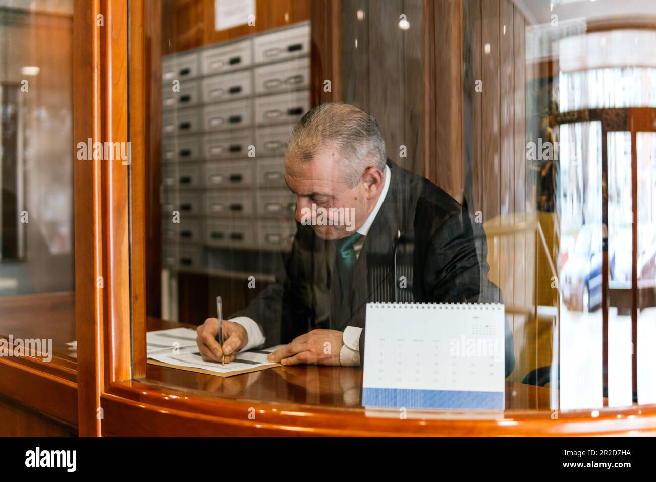 concierge typing in the portal of a building Stock Photo - Alamy