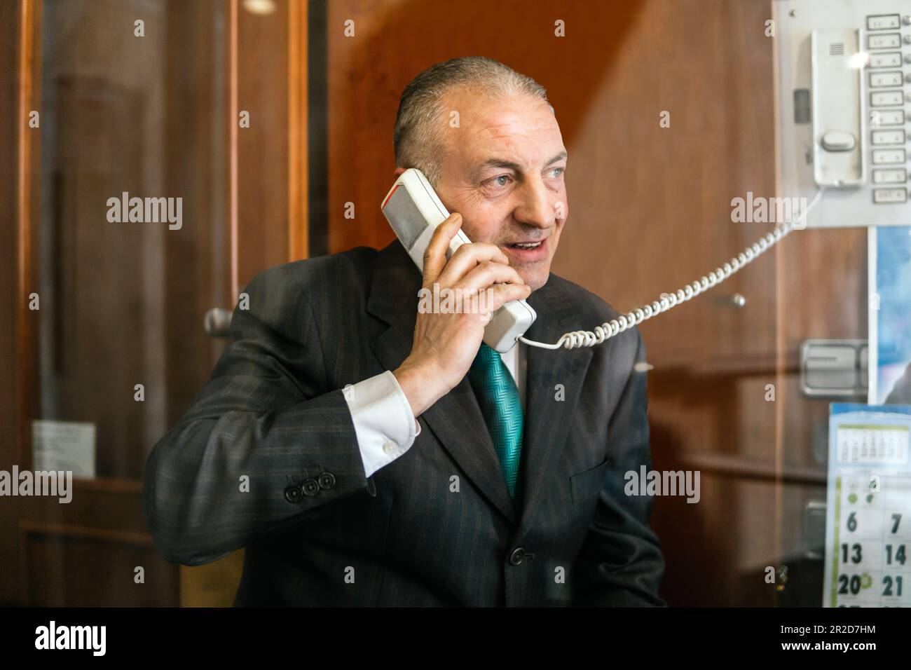 concierge talking on the phone Stock Photo - Alamy