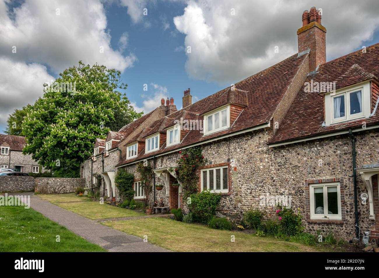 East Dean, May 16th 2023: Flint cottages on the village green Stock ...