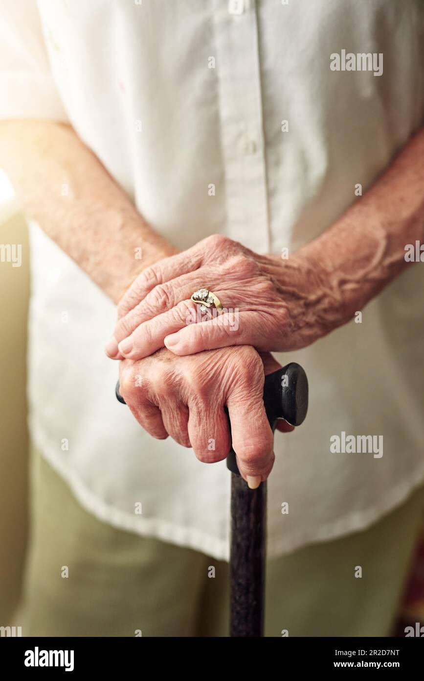 Hands, cane and closeup of senior woman with disabled injury with ...