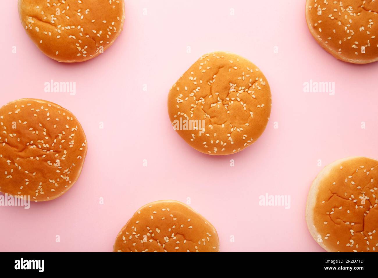 The burger buns on a pink background. Top view Stock Photo - Alamy