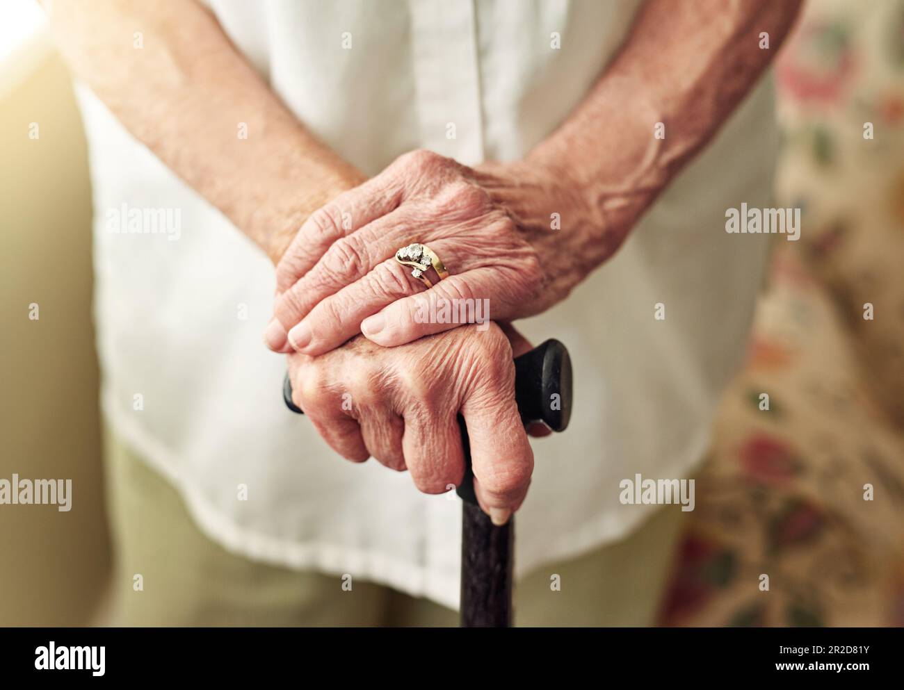 Hands, walking stick and closeup with senior woman, injury and disabled with balance in ...