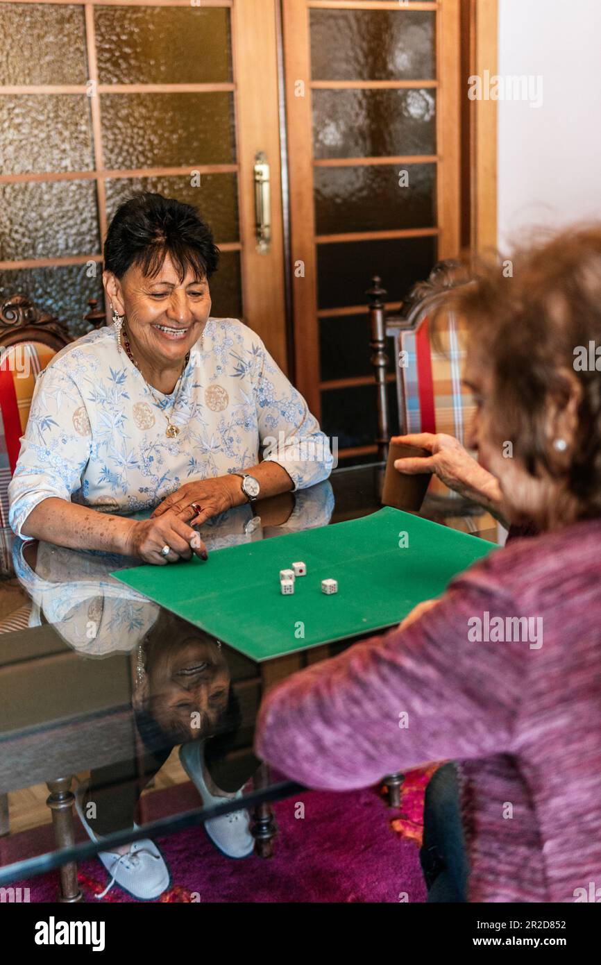 two senior friends playing dice, playing board games Stock Photo - Alamy