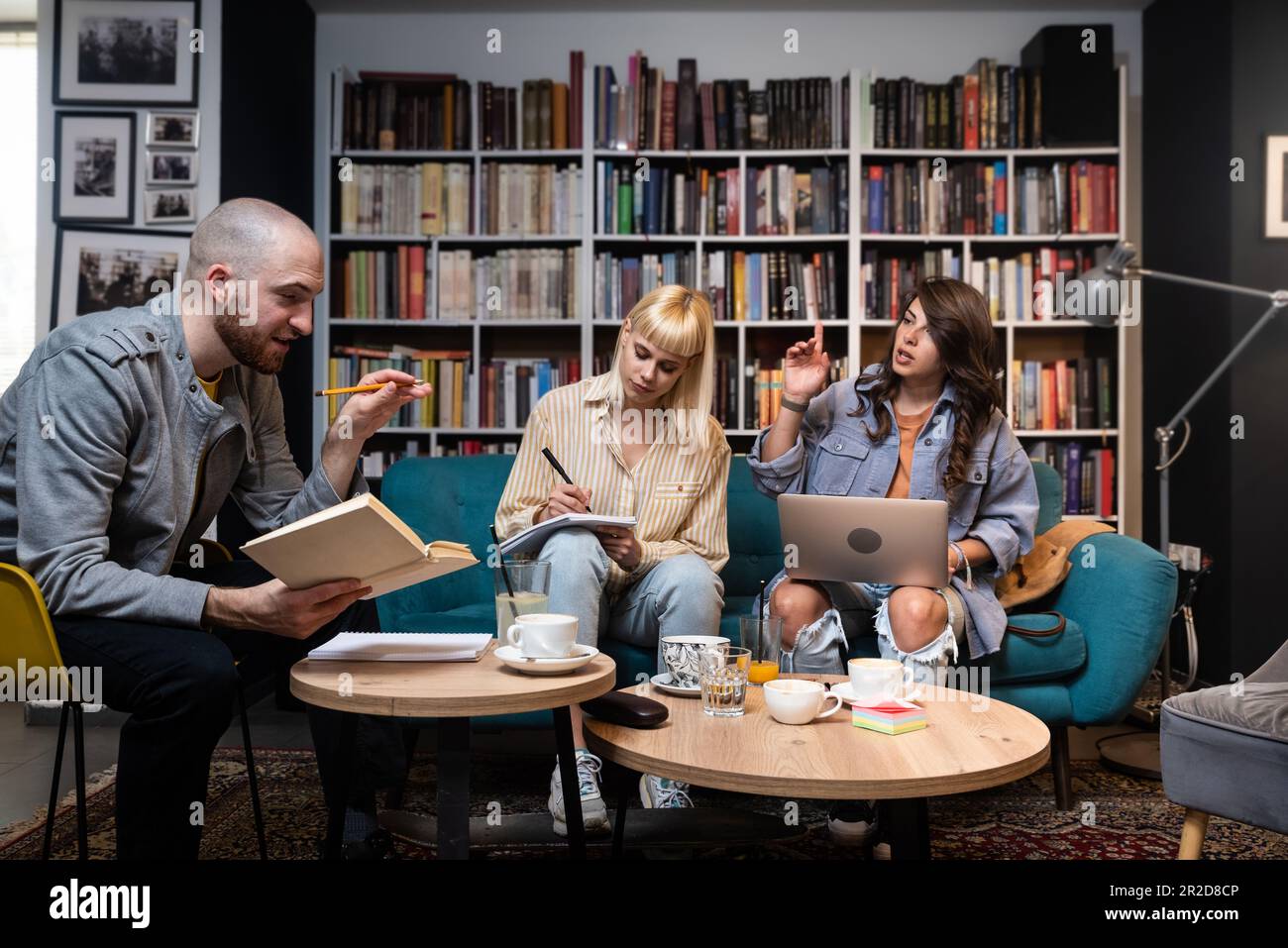Happy diverse group of college students working together on study project in university library ...