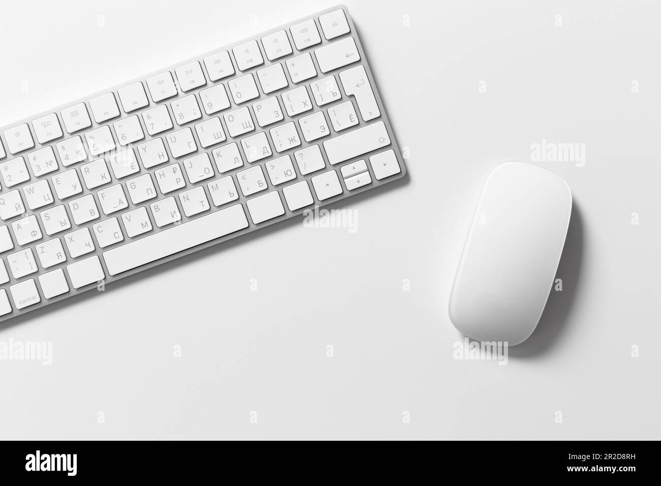 Computer keyboard and mouse on top of white desktop Stock Photo - Alamy