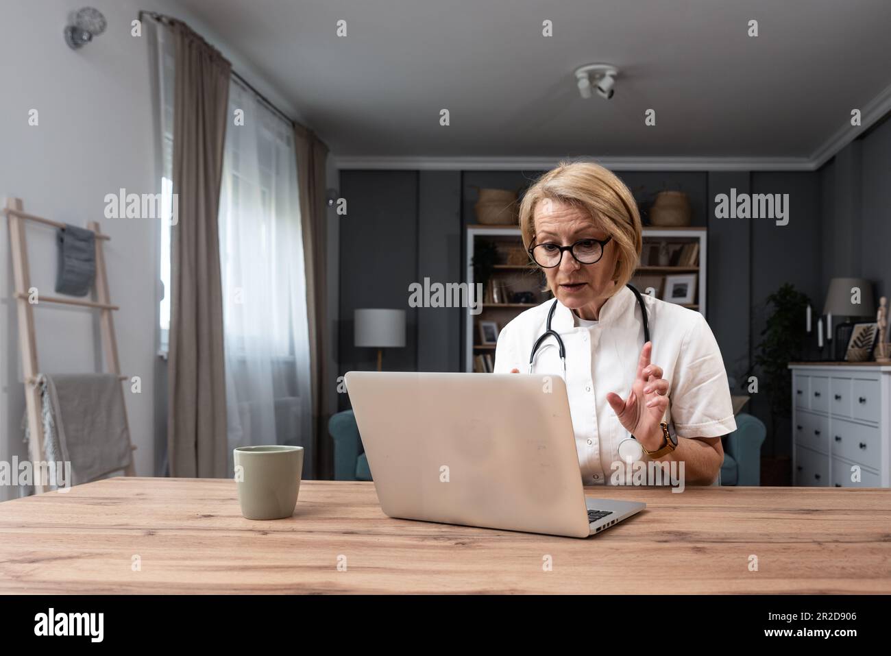 Senior female doctor working from home office from home practice ...