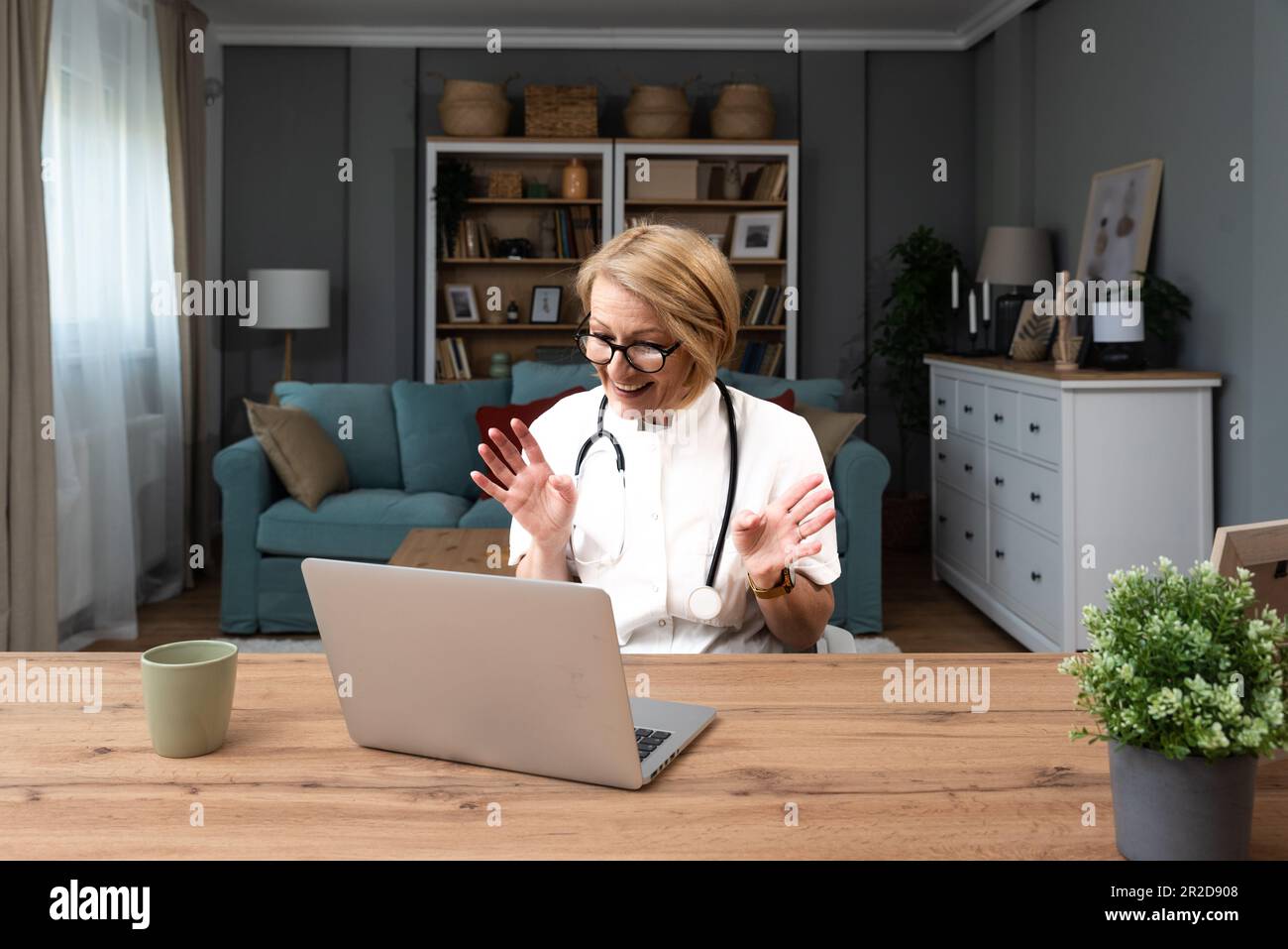 Senior female doctor working from home office from home practice ...
