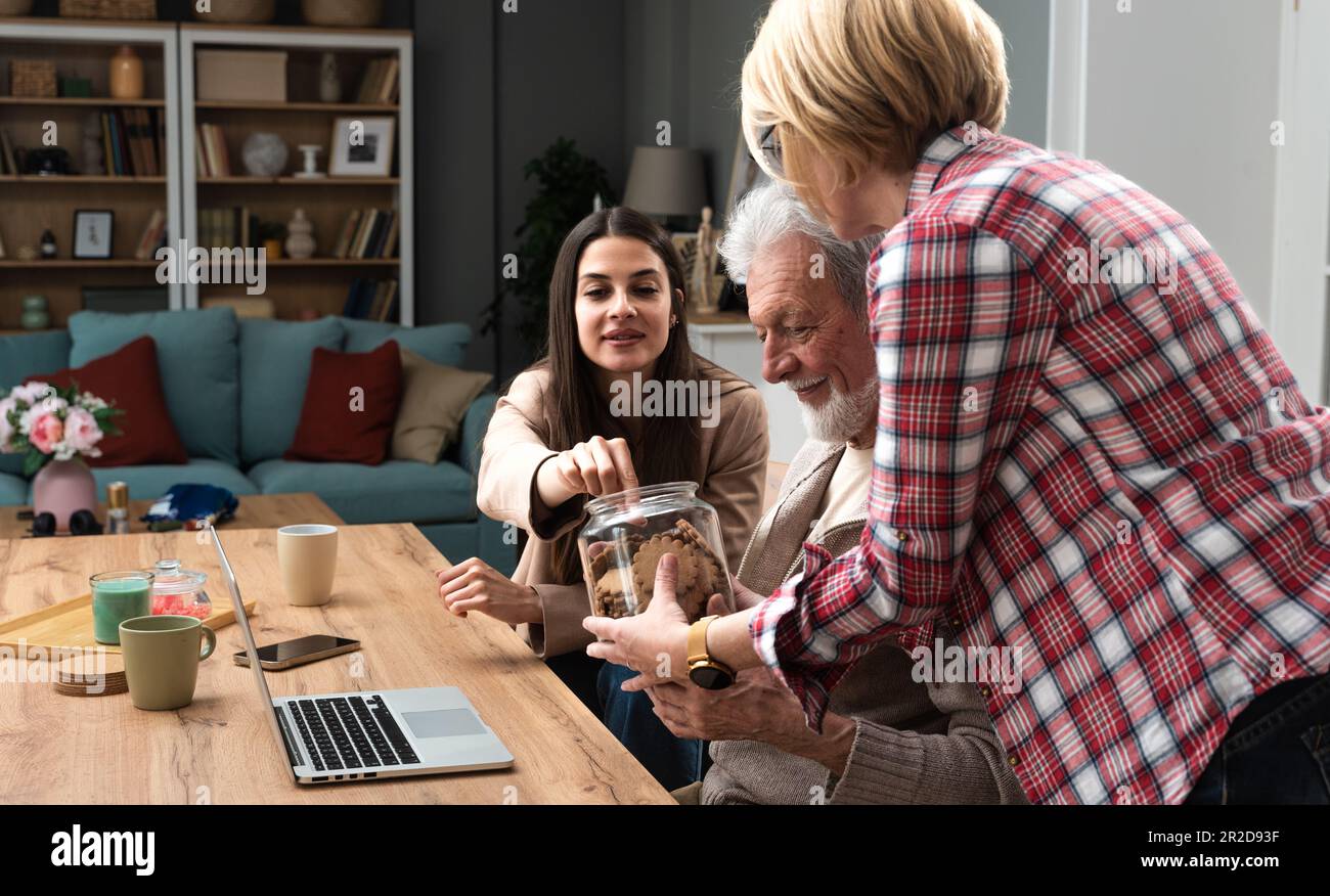 Beautiful happy family together at the table father mother daughter ... Beautiful happy family together at the table father mother daughter ...