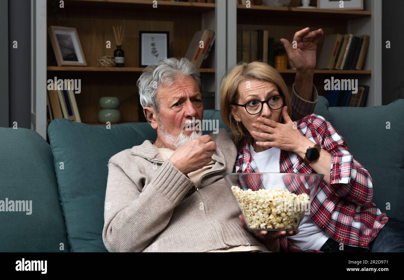Elderly couple watching bad news, quiz or competition with displeasure ...