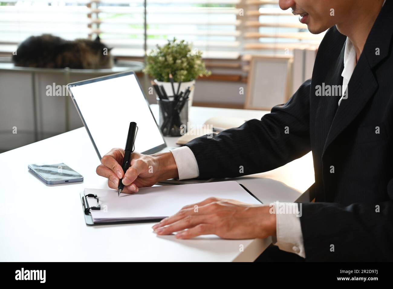 Side view of adult male analyst working bookkeeping documents, signing ...