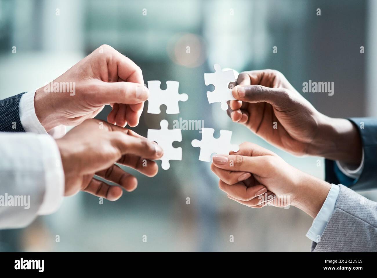 Puzzle, hands and group of people for solution, teamwork and goals ...