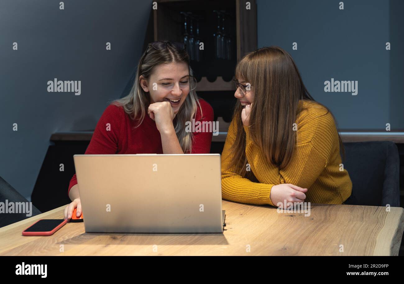 Two Happy Ladies Using Laptop Computer Working And Learning Online ...