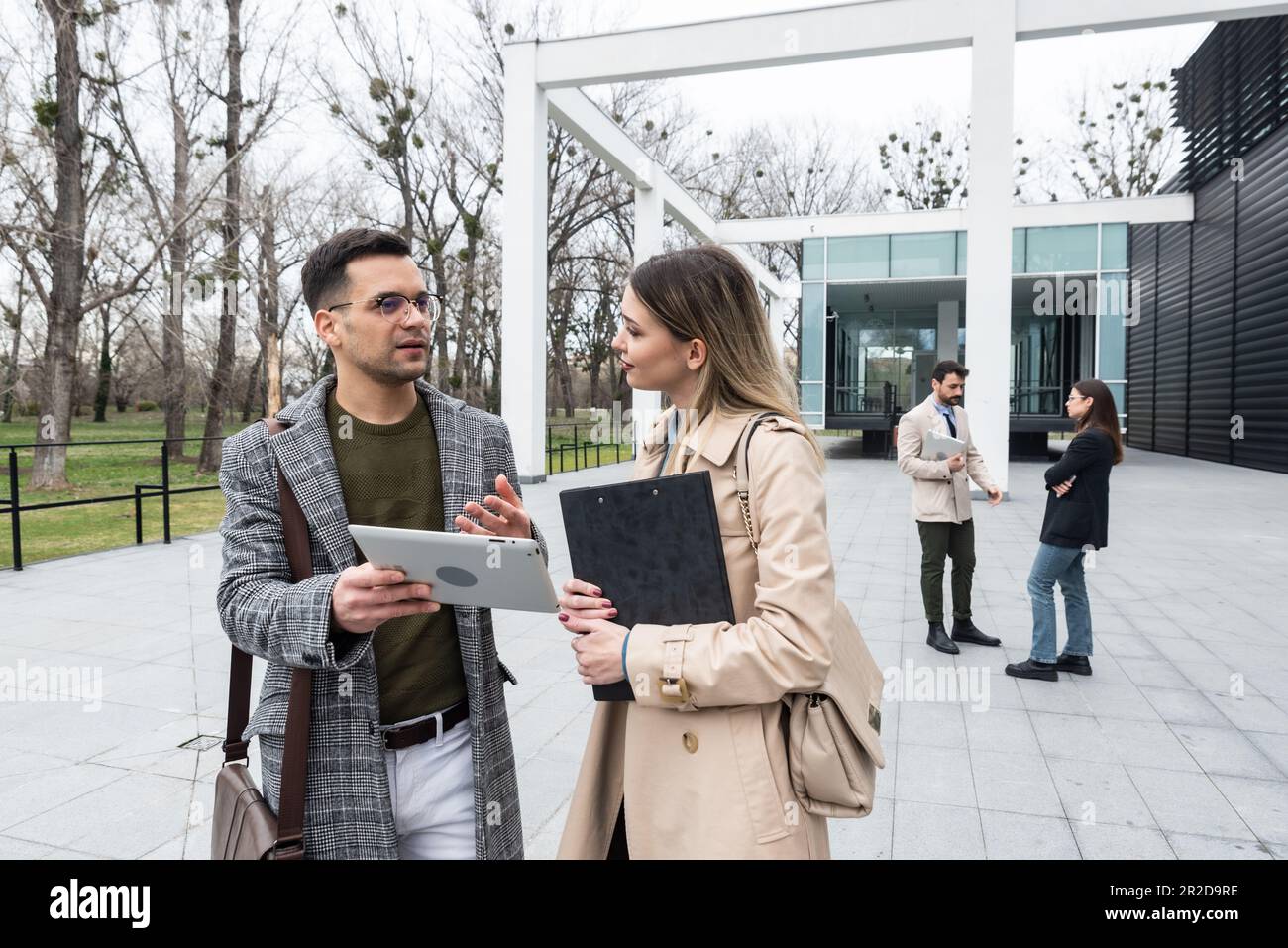 Quick briefing before meeting. Group of cheerful young successful ...
