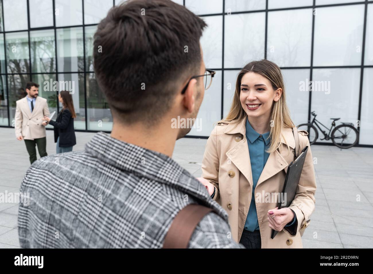 Quick briefing before meeting. Group of cheerful young successful ...