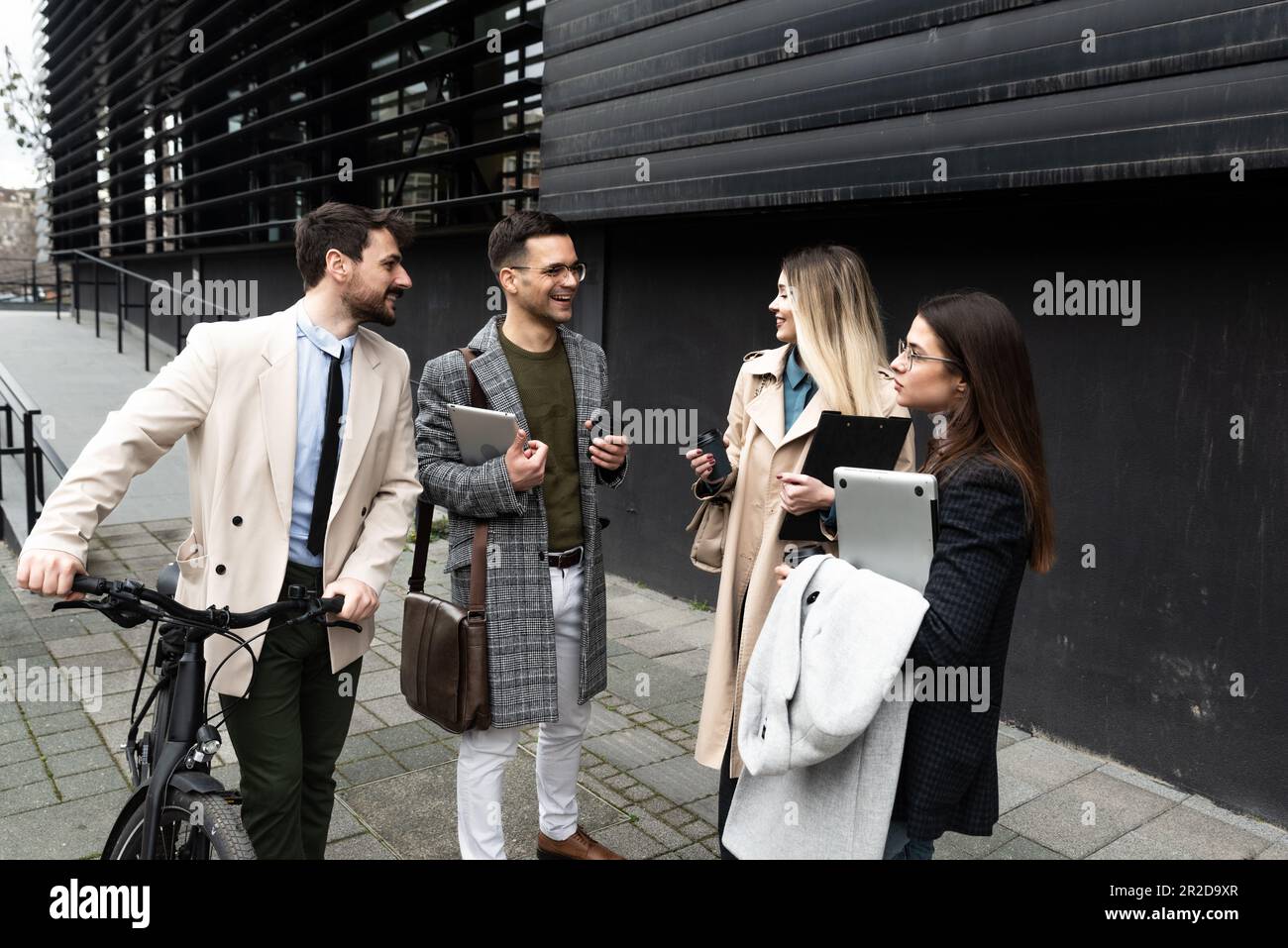 Quick briefing before meeting. Group of cheerful young successful ...