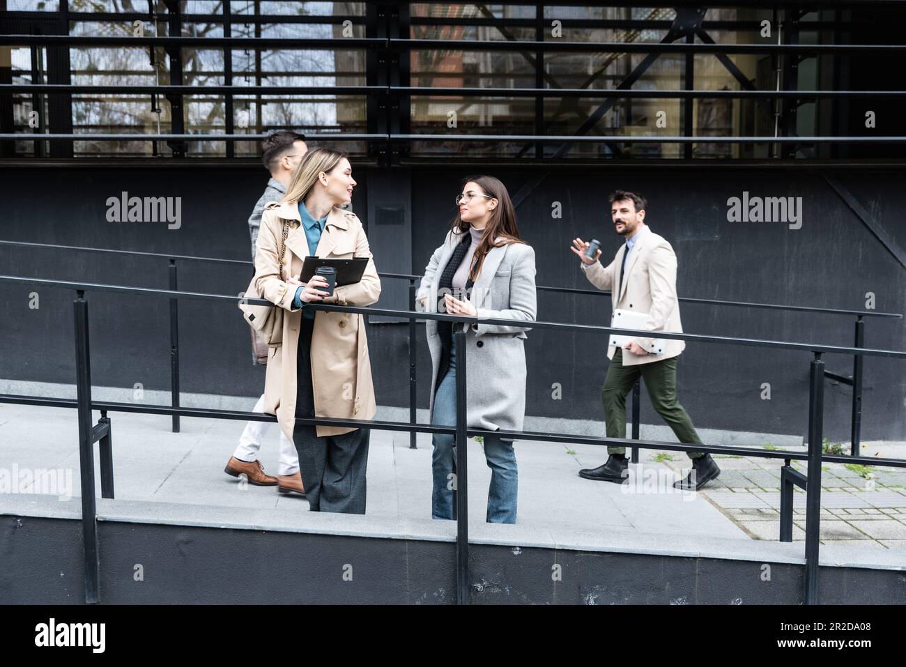 Quick briefing before meeting. Group of cheerful young successful ...
