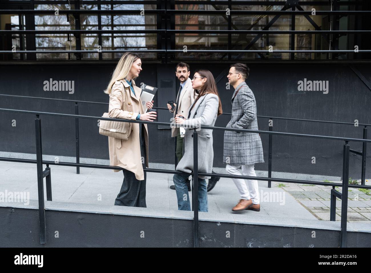 Quick briefing before meeting. Group of cheerful young successful ...