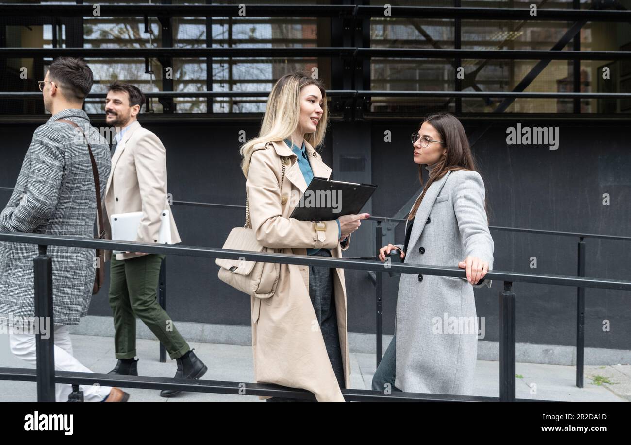 A regular day for working people standing talking walking in front of ...