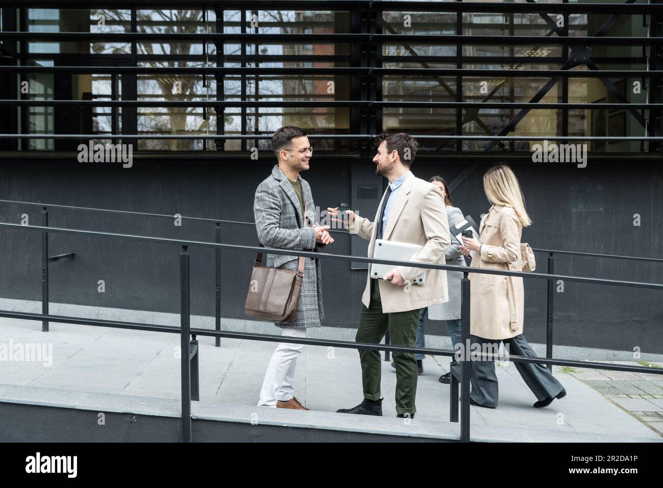 A regular day for working people standing talking walking in front of ...