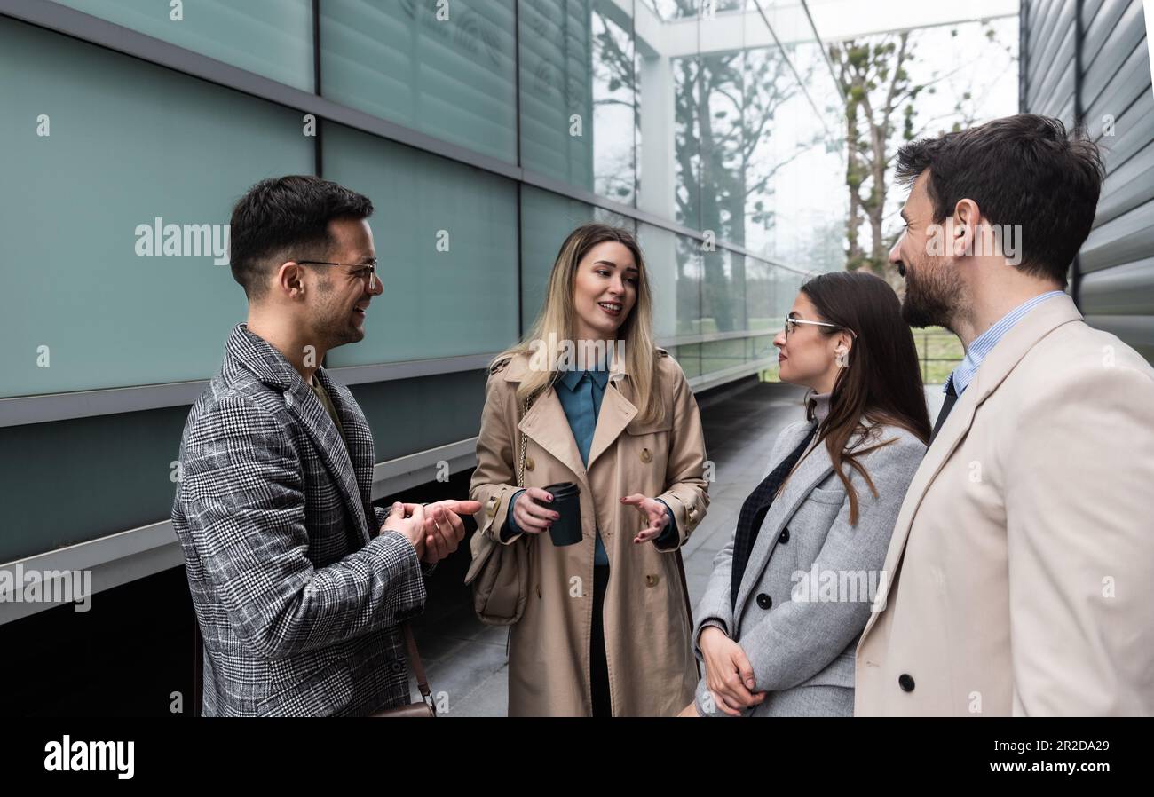 Quick briefing before meeting. Group of cheerful young successful ...