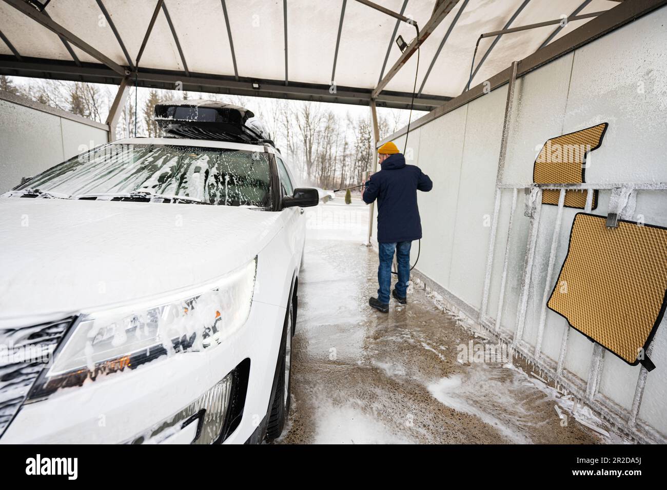 Man washing high pressure water american SUV car with roof rack at self ...