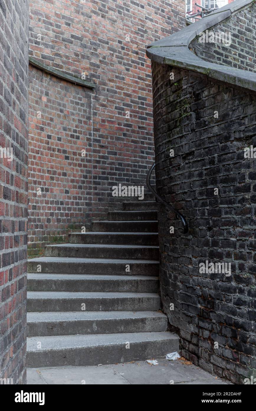 A mysterious and hidden old back alley with staircase in London at ...