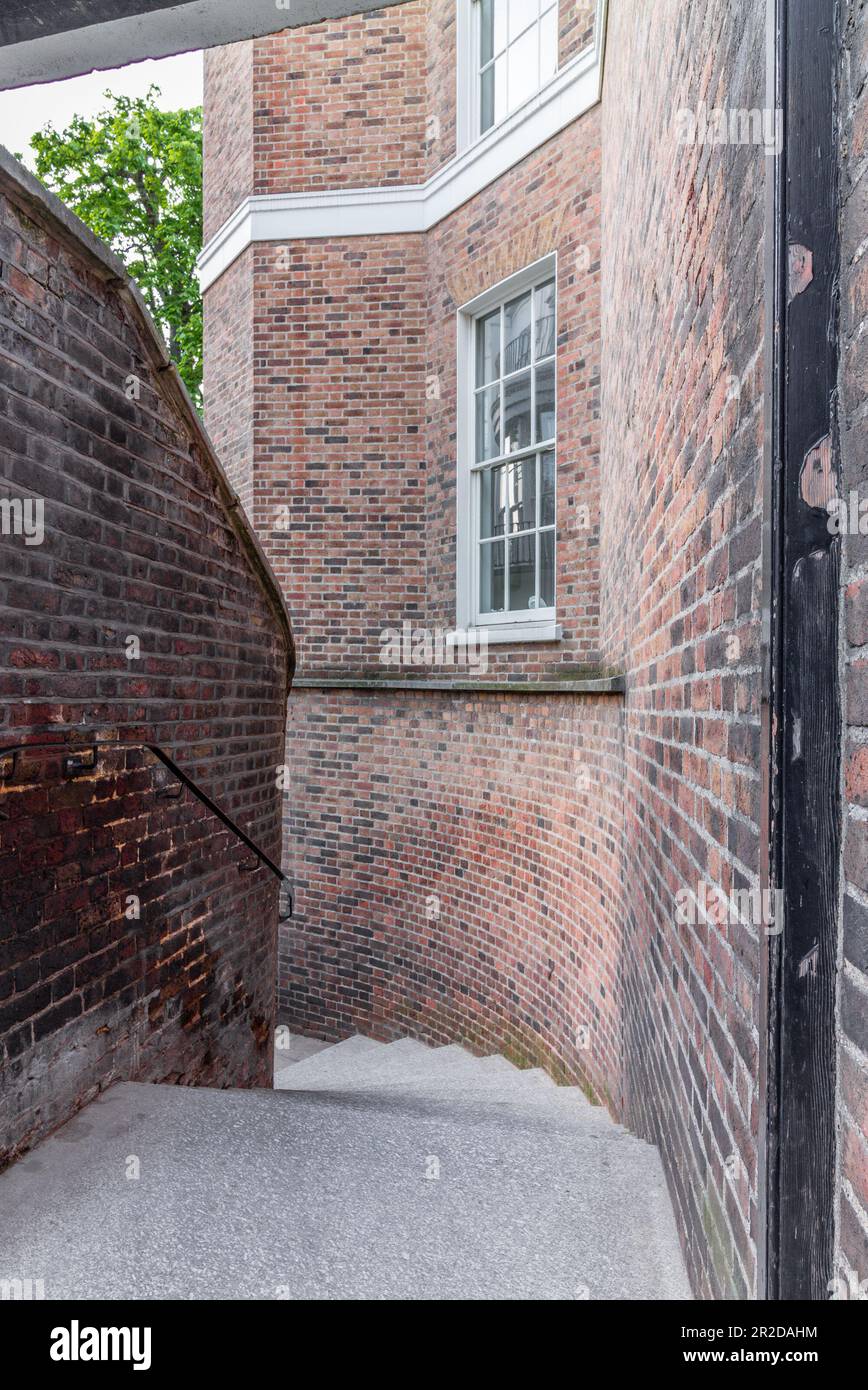 A mysterious and hidden old back alley with staircase in London at ...
