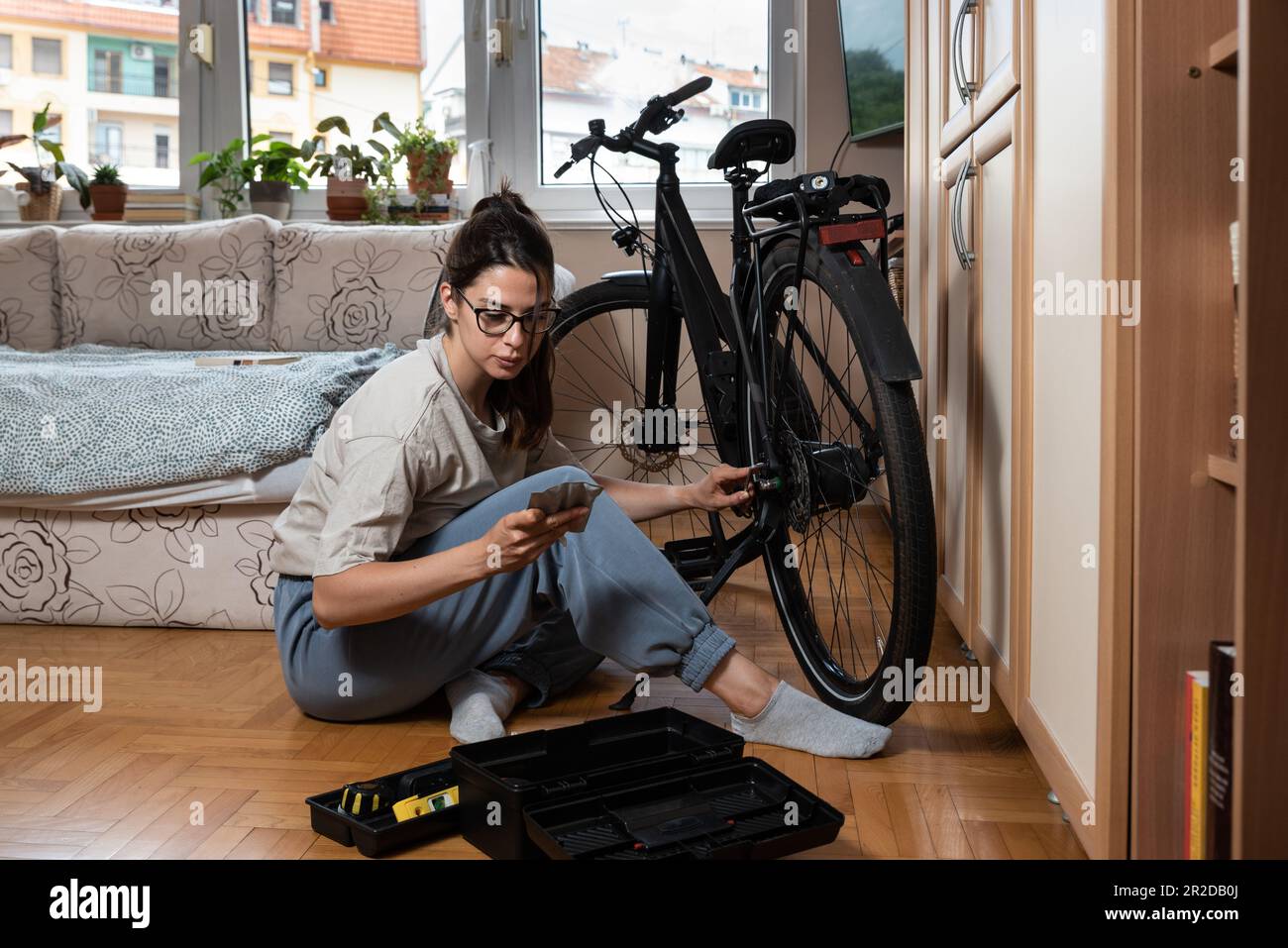 Young self learned woman or girl mechanic fixing and repairing her ...