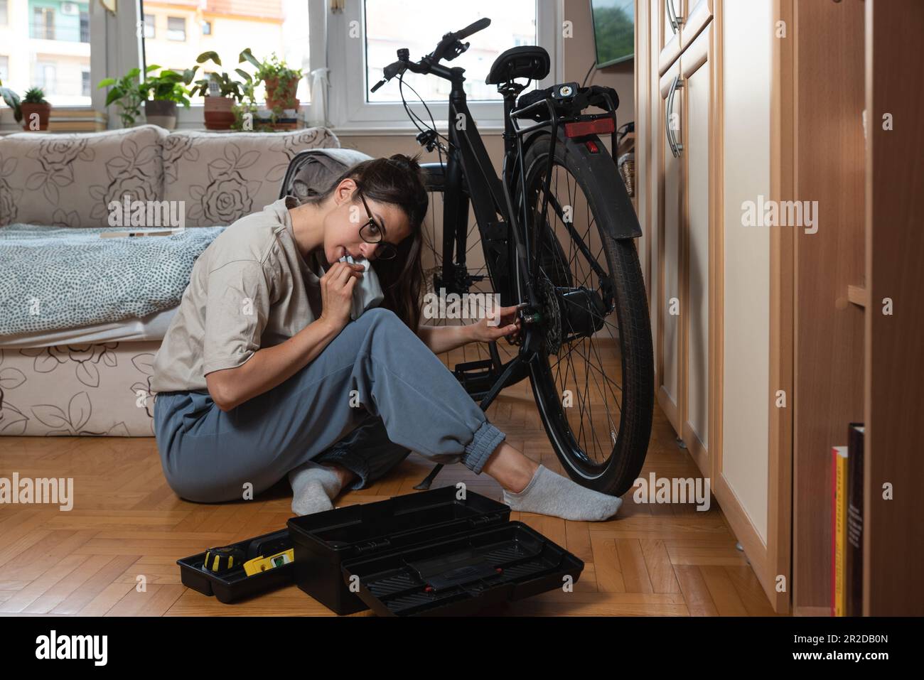 Young self learned woman or girl mechanic fixing and repairing her ...