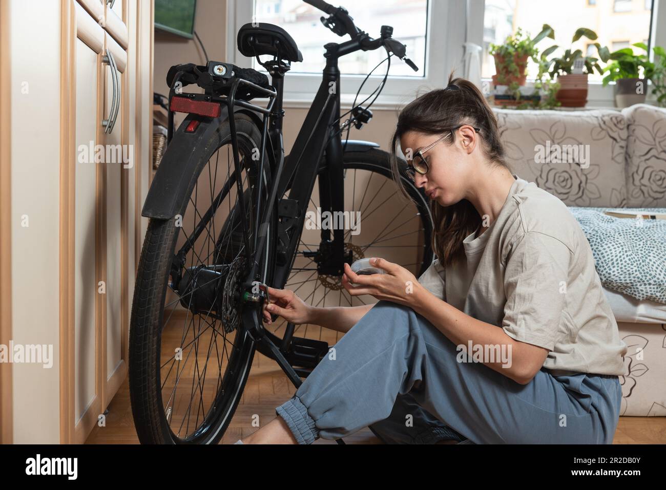 Young self learned woman or girl mechanic fixing and repairing her ...