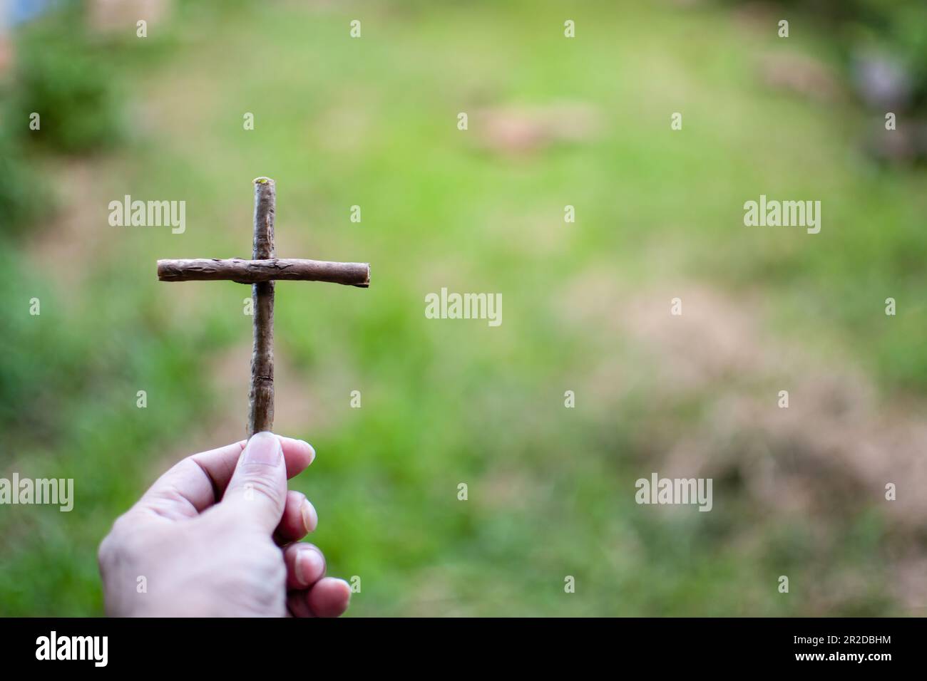 His left-hand holding a cross. right copyspace for entering text ...
