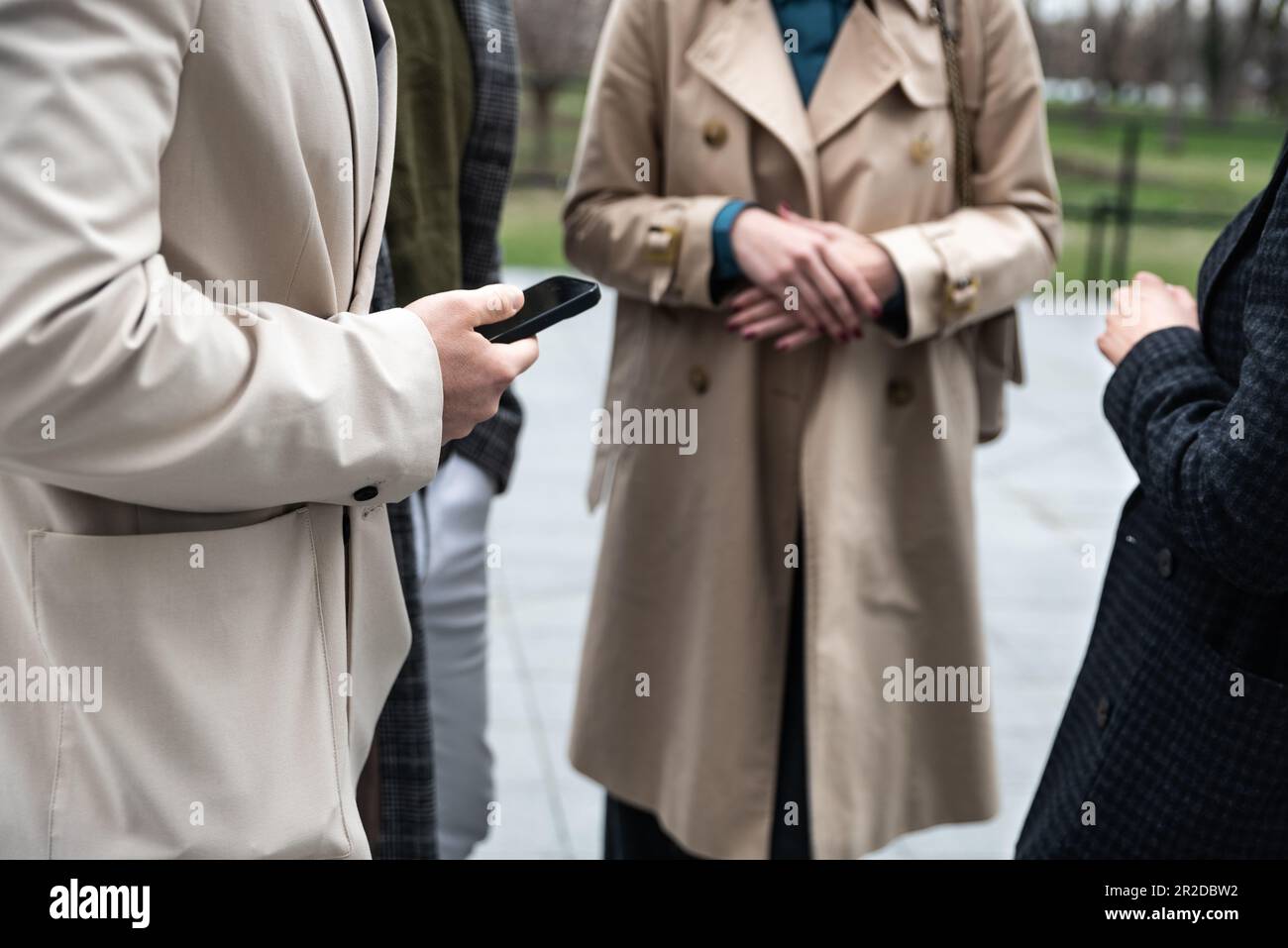 Unrecognizable young businesspeople standing in front of office ...