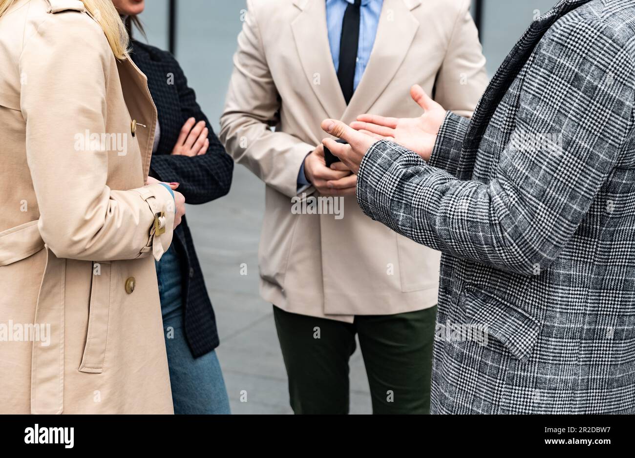 Unrecognizable young businesspeople standing in front of office ...