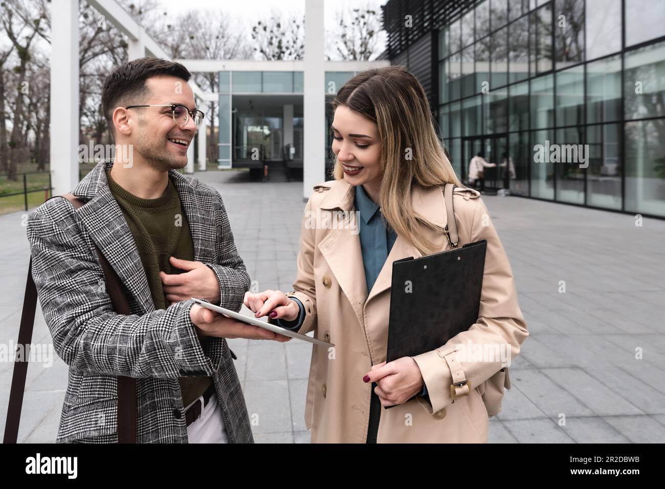 Young business people businessman and businesswoman walk from office ...