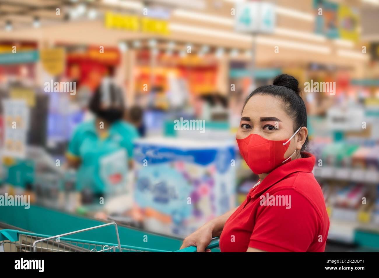 Women wearing a mask Shopping and paying at the cashier counter in the ...