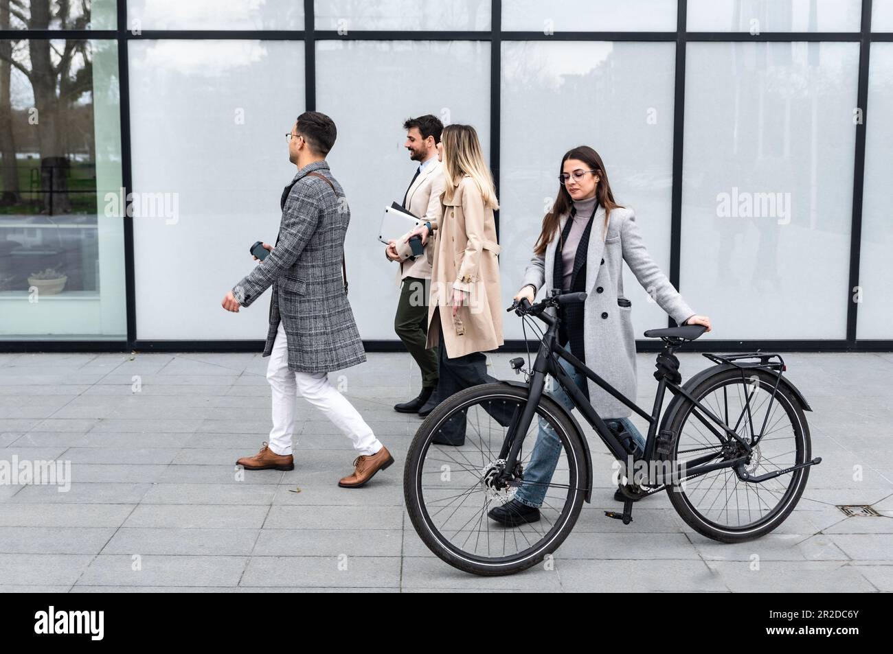 Group of business people walking outside in front of office buildings ...