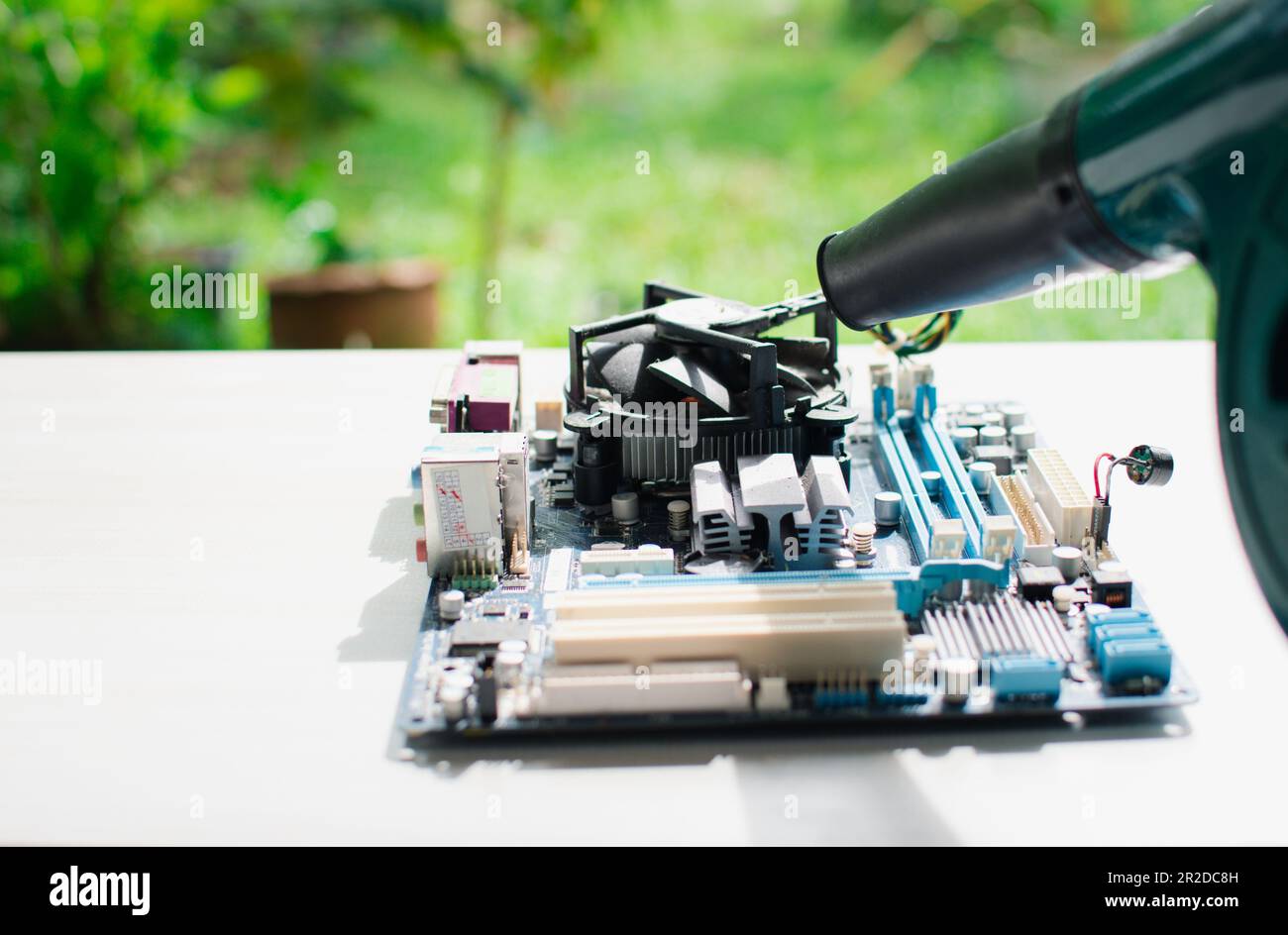 maintenance mainboard or motherboard concept. engineer cleaning a ...