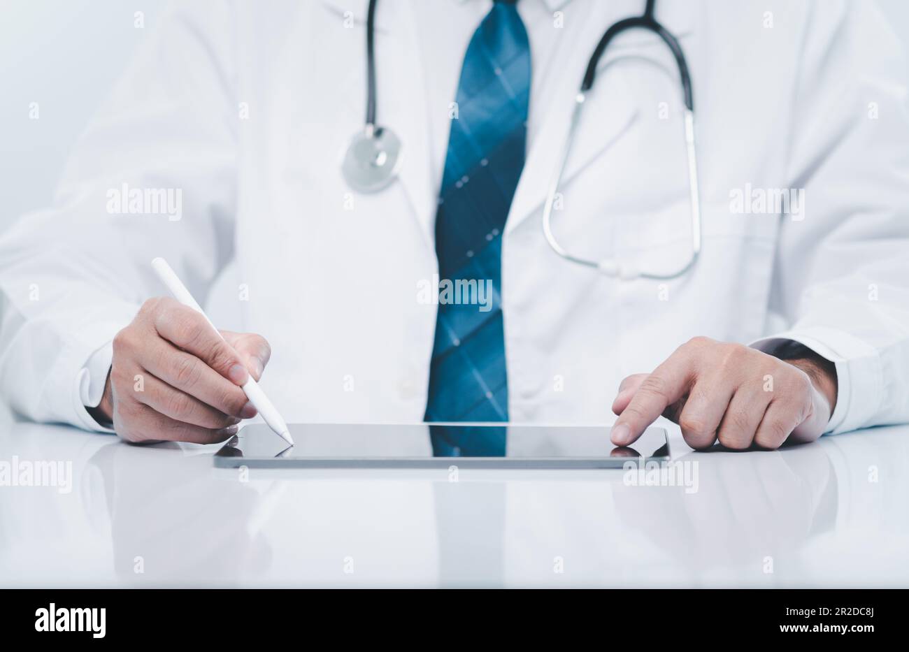 professional doctor man wearing a uniform using a device tablet of ...