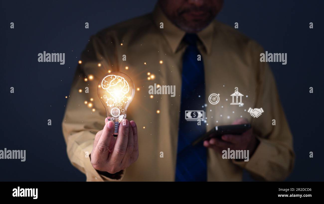 Hand of a man holding illuminated light bulb, concept creativity with ...