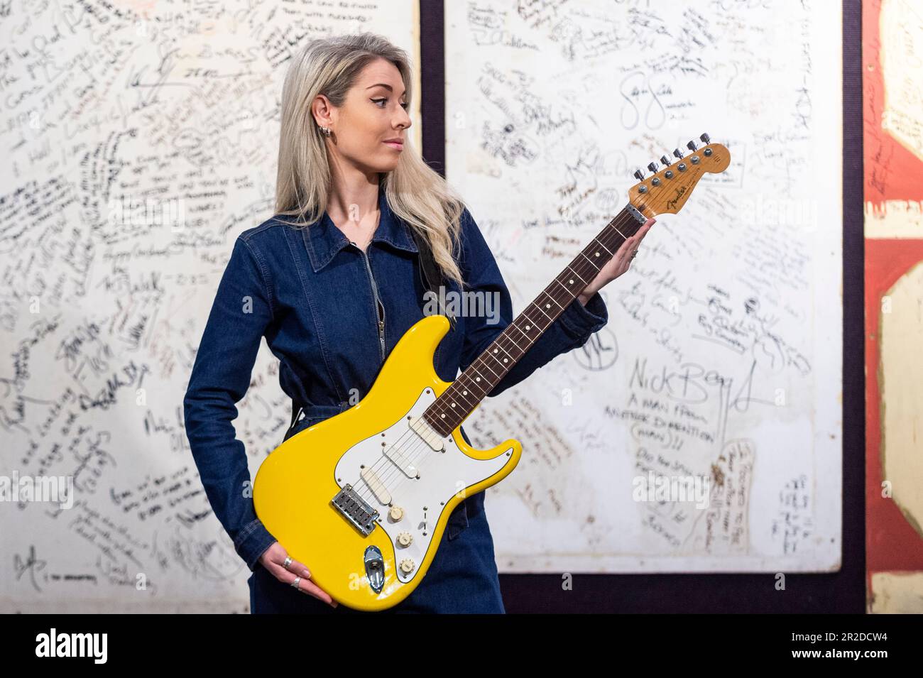 London, UK. 19 May 2023. A staff member with ‘A graffiti yellow working ...
