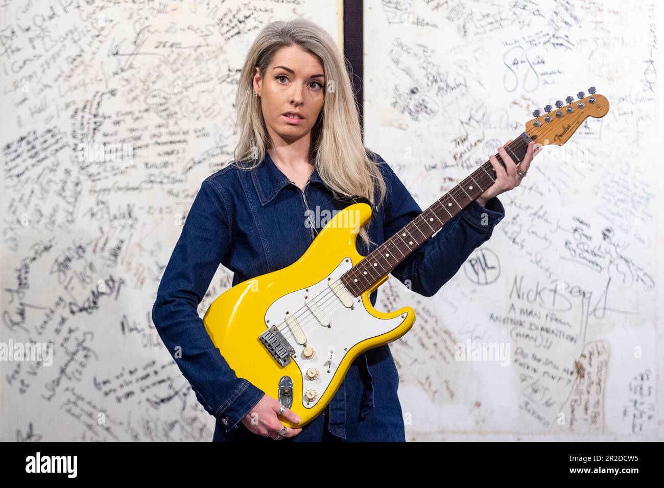 London, UK. 19 May 2023. A staff member with ‘A graffiti yellow working ...
