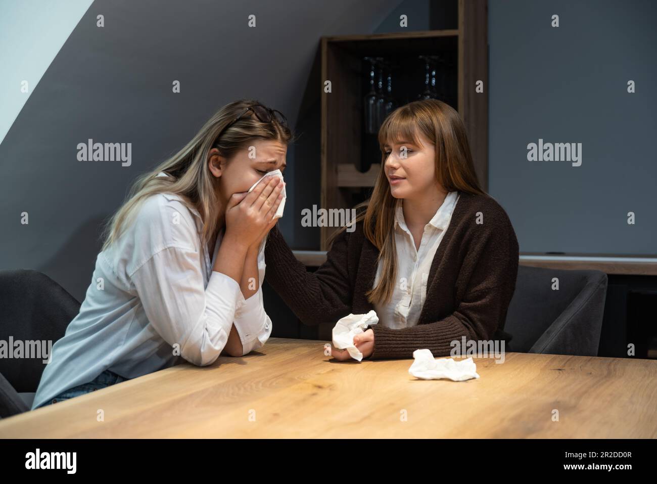 Young friend woman comforting her sad depressed colleague in office who ...